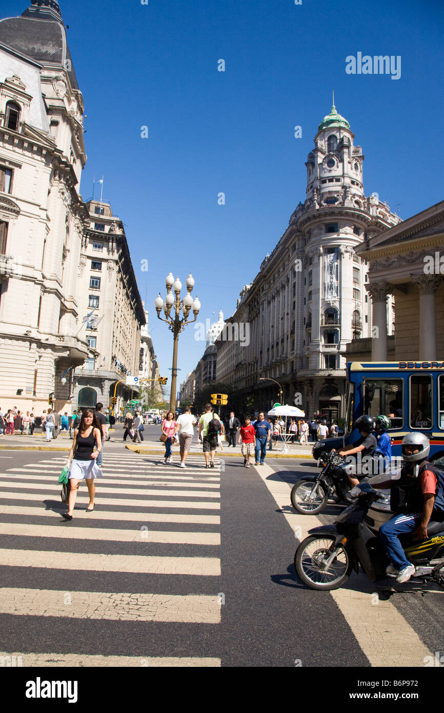 Female lady 30 s crossing pedestrian traffic Plaza de Mayo city centre ...