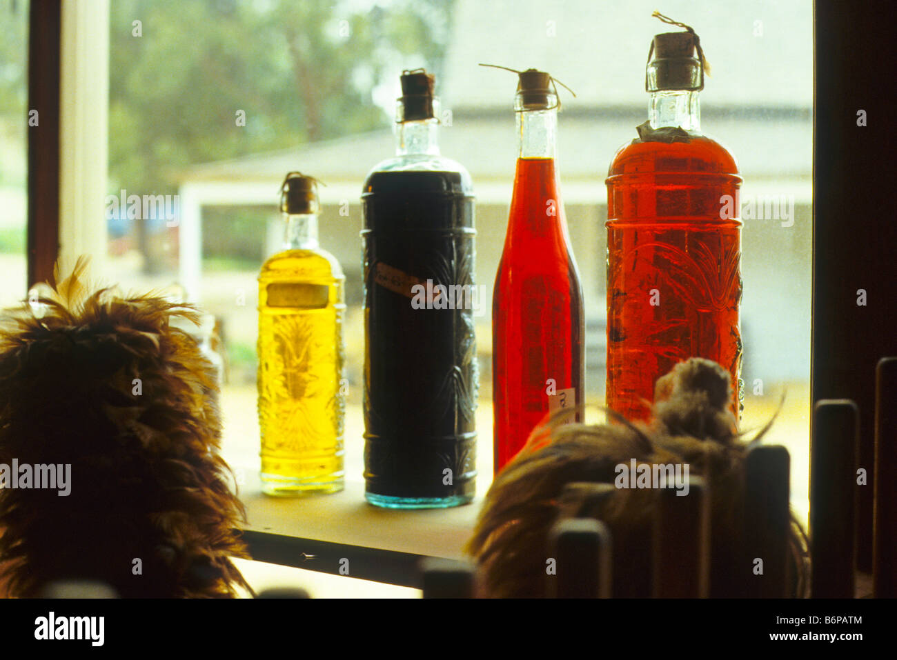 Bottles filled with colored liquid rest on shelf of old time store in ...