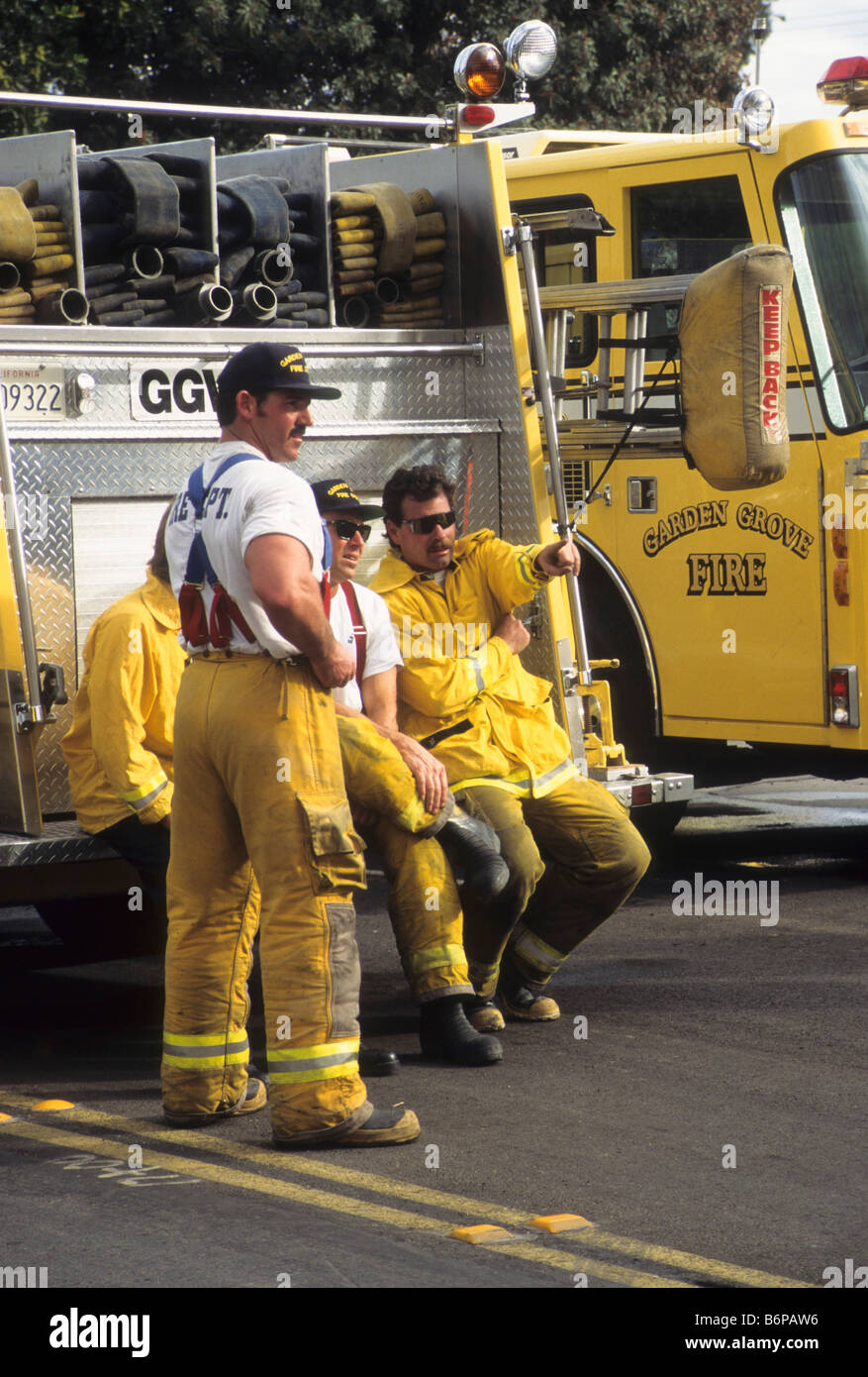 Firemen rest after putting out a fire Stock Photo - Alamy