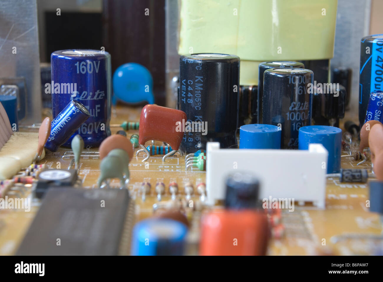 Electrolytic capacitors standing tall on an electronic circuit board ...