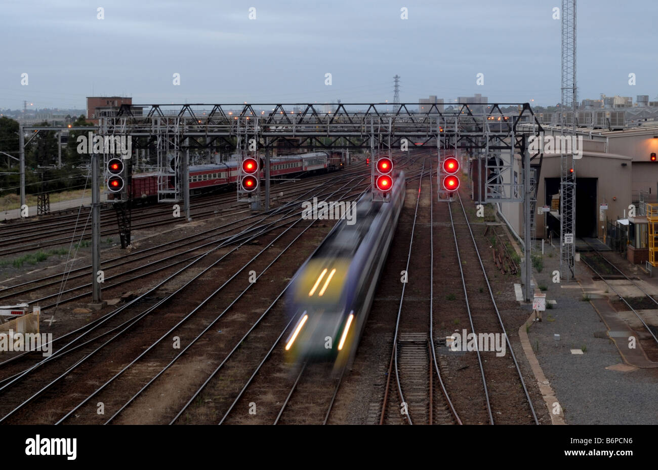 Speeding train in depot Stock Photo - Alamy