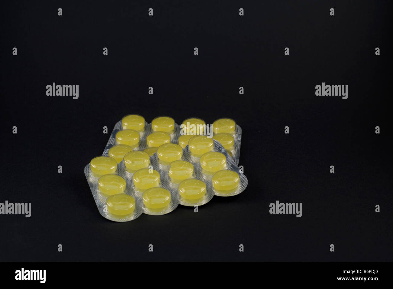 Strips of yellow drugs isolated on black Stock Photo - Alamy