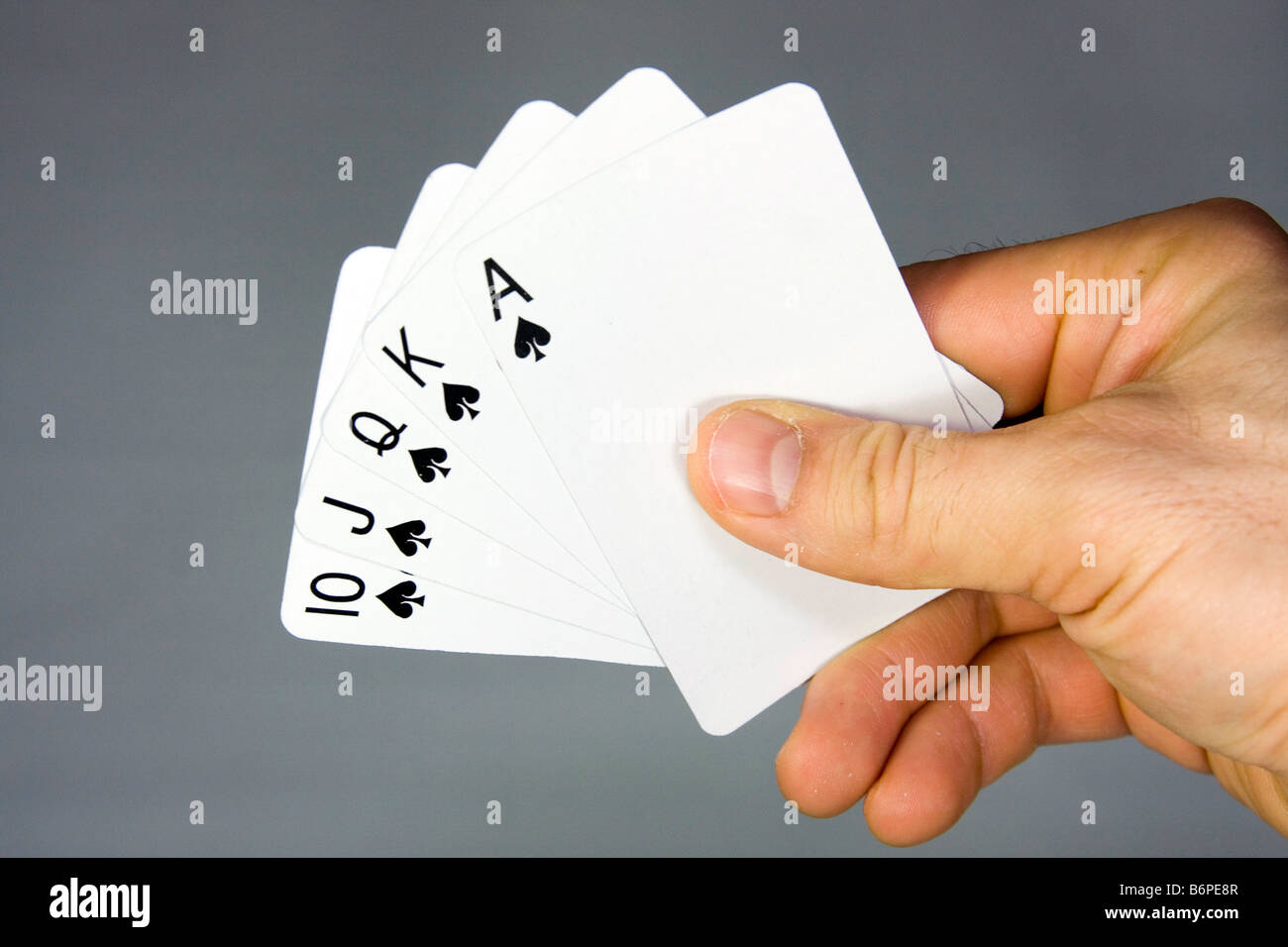 Hand with poker cards. Royal flush Stock Photo - Alamy