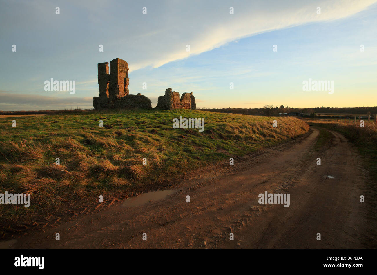 A farm track curves around the ruins of Bawsey Old Church in Norfolk ...