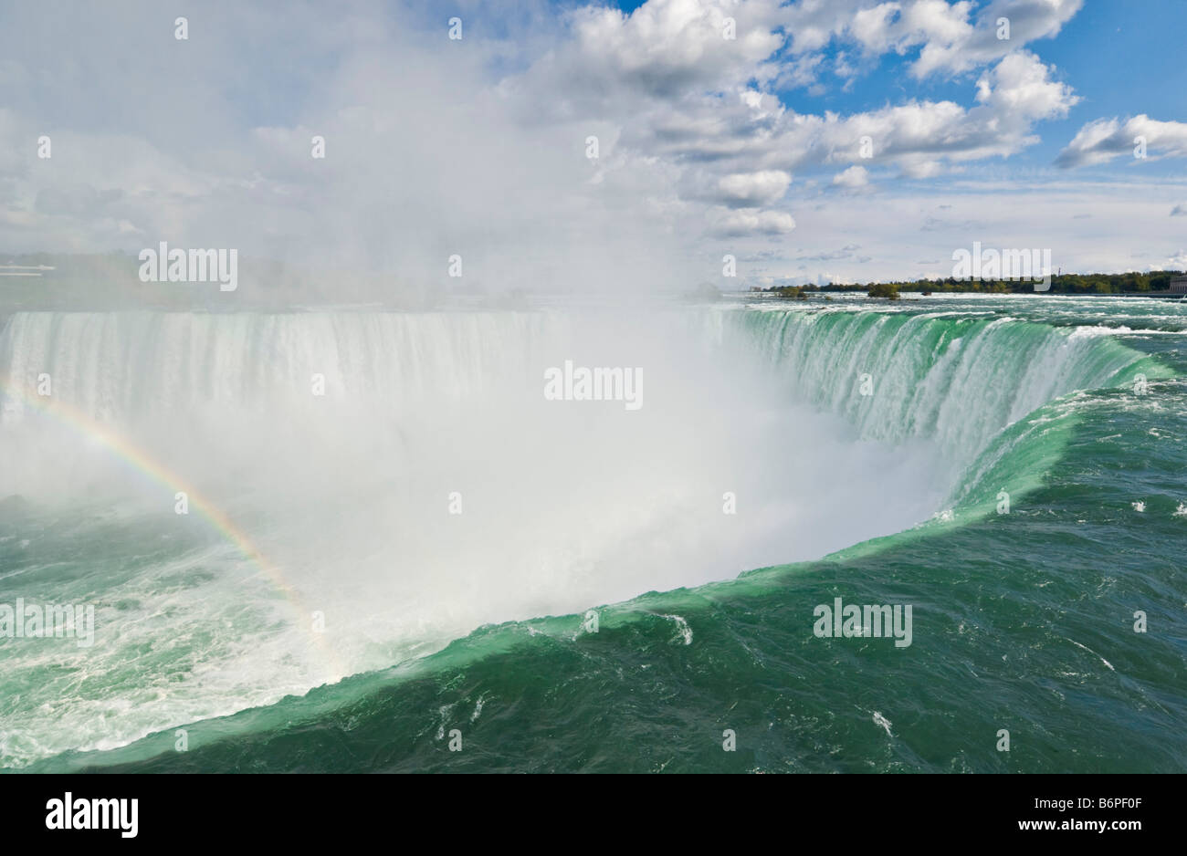 Rainbow in the spray of the Horseshoe falls waterfall at Niagara Falls ...