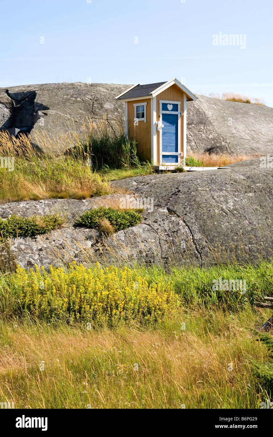 Small yellow house on an island in nature Stock Photo - Alamy