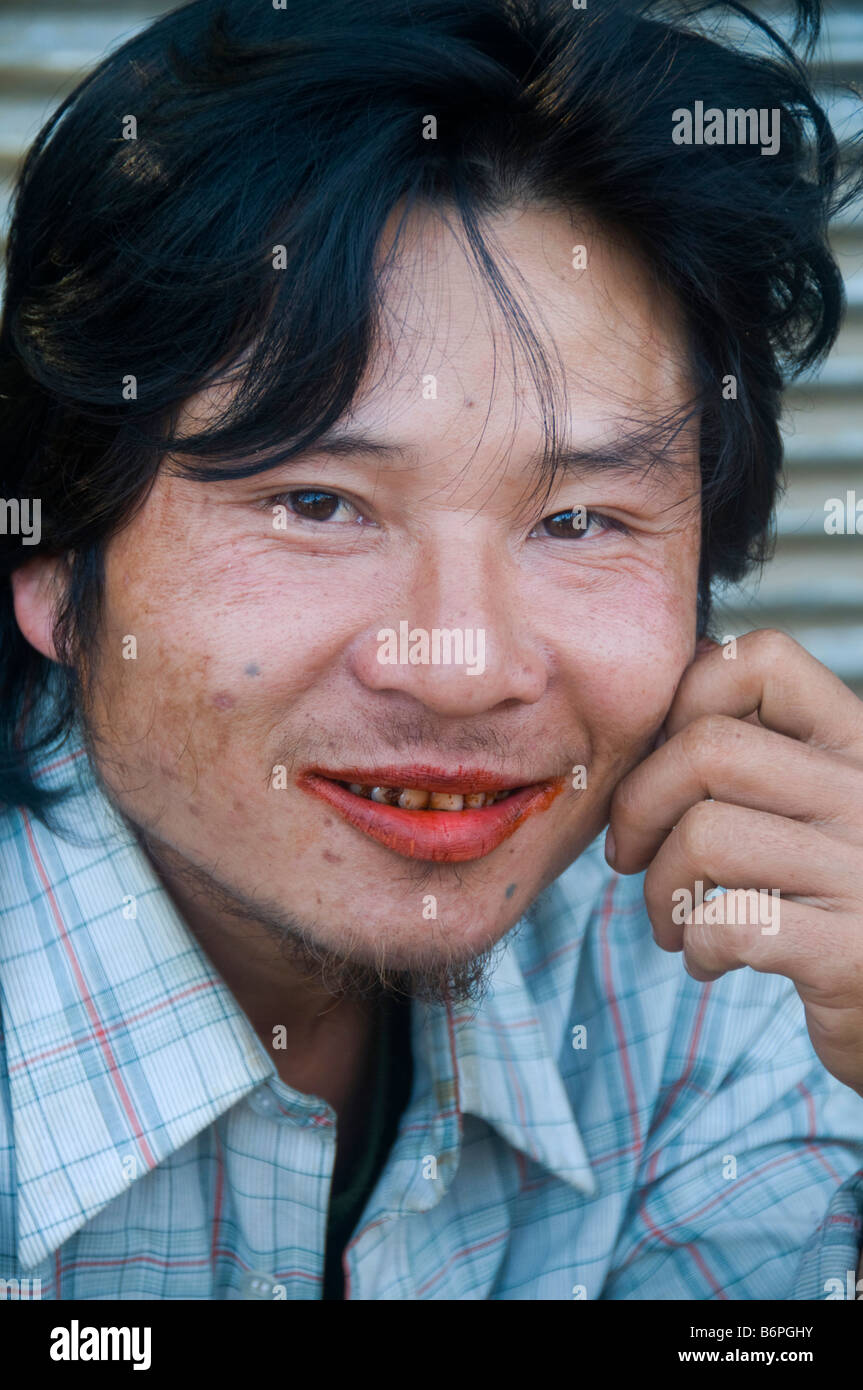 portrait of a Burmese man with betel nut stains on his lips in the ...