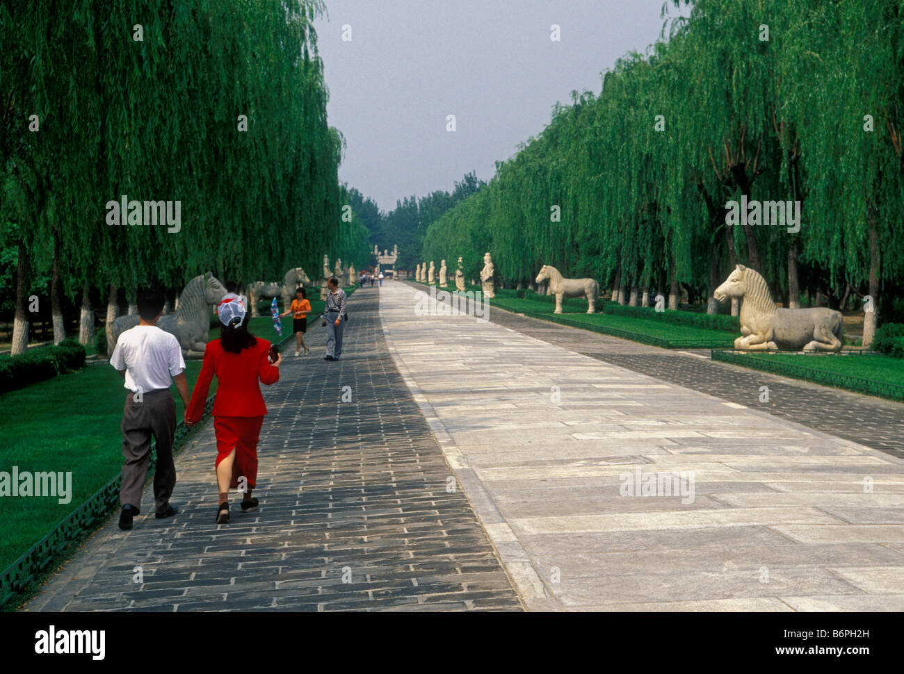 Chinese people man and woman tourists and stone statues along Spirit ...
