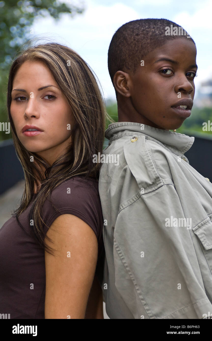 Two girls, back to back Stock Photo - Alamy