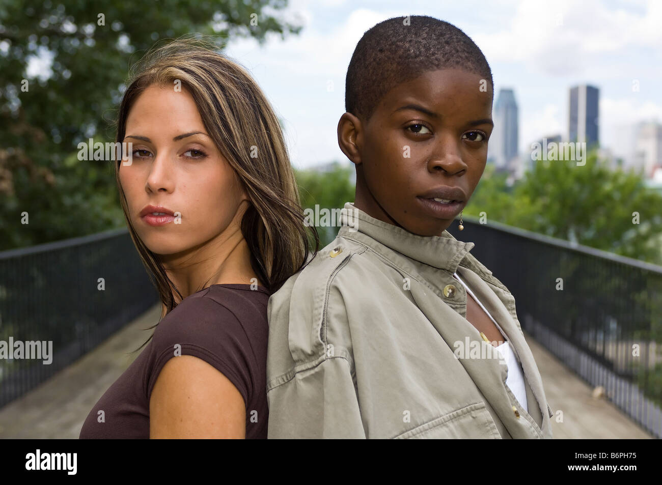 Two girls, back to back Stock Photo - Alamy