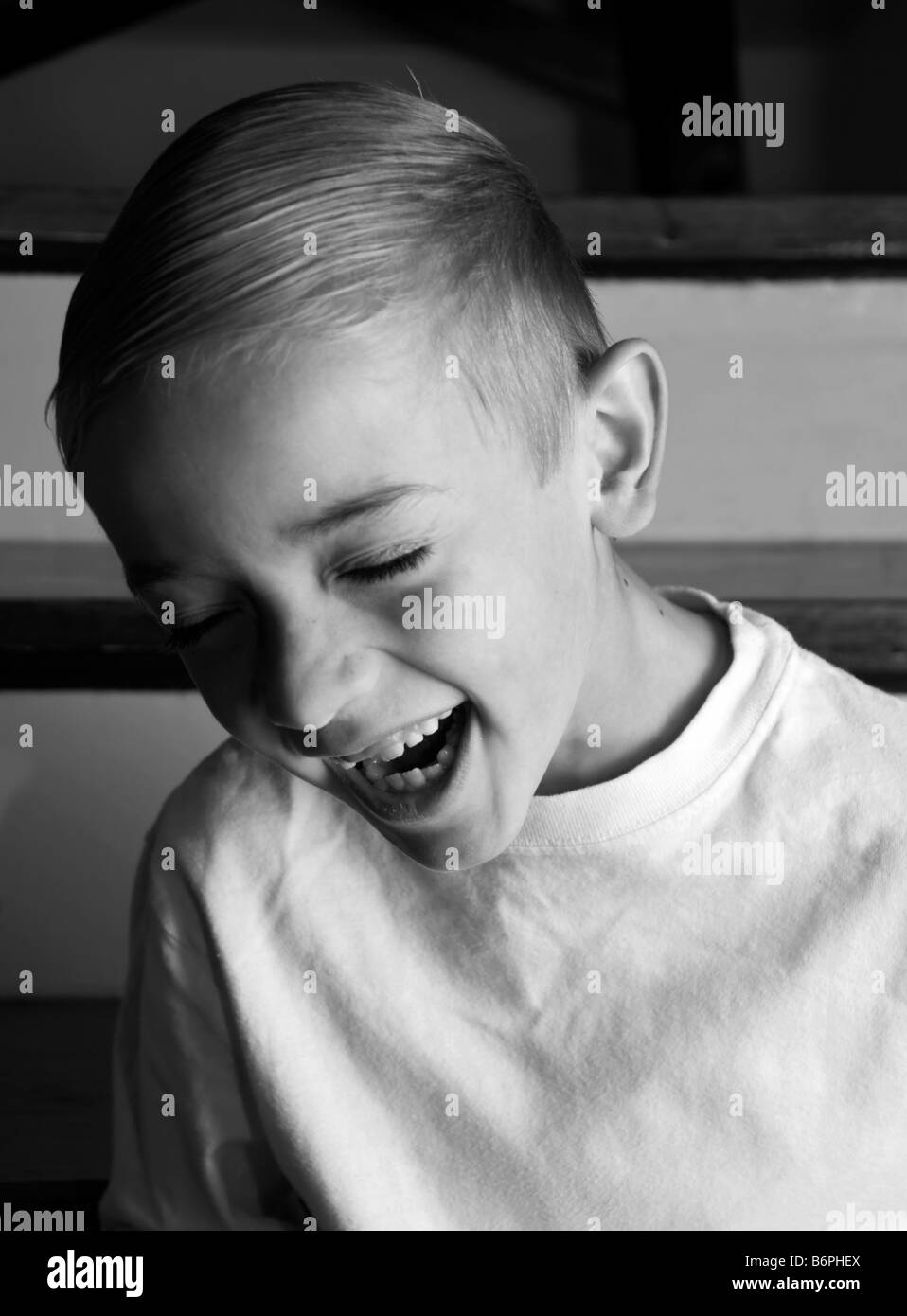 Young boy laughing during photo shoot Stock Photo - Alamy