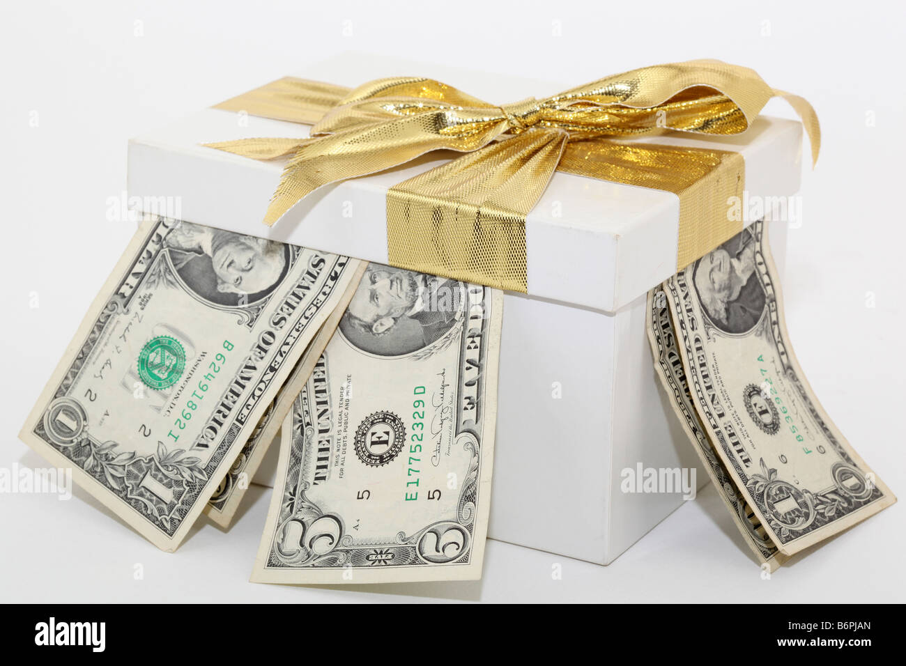 expensive white gift box with gold ribbon and bow and dollars Stock ...
