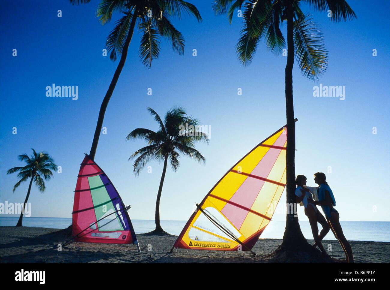 Couple relaxing after windsurfing, palm trees and ocean, Miami Stock ...