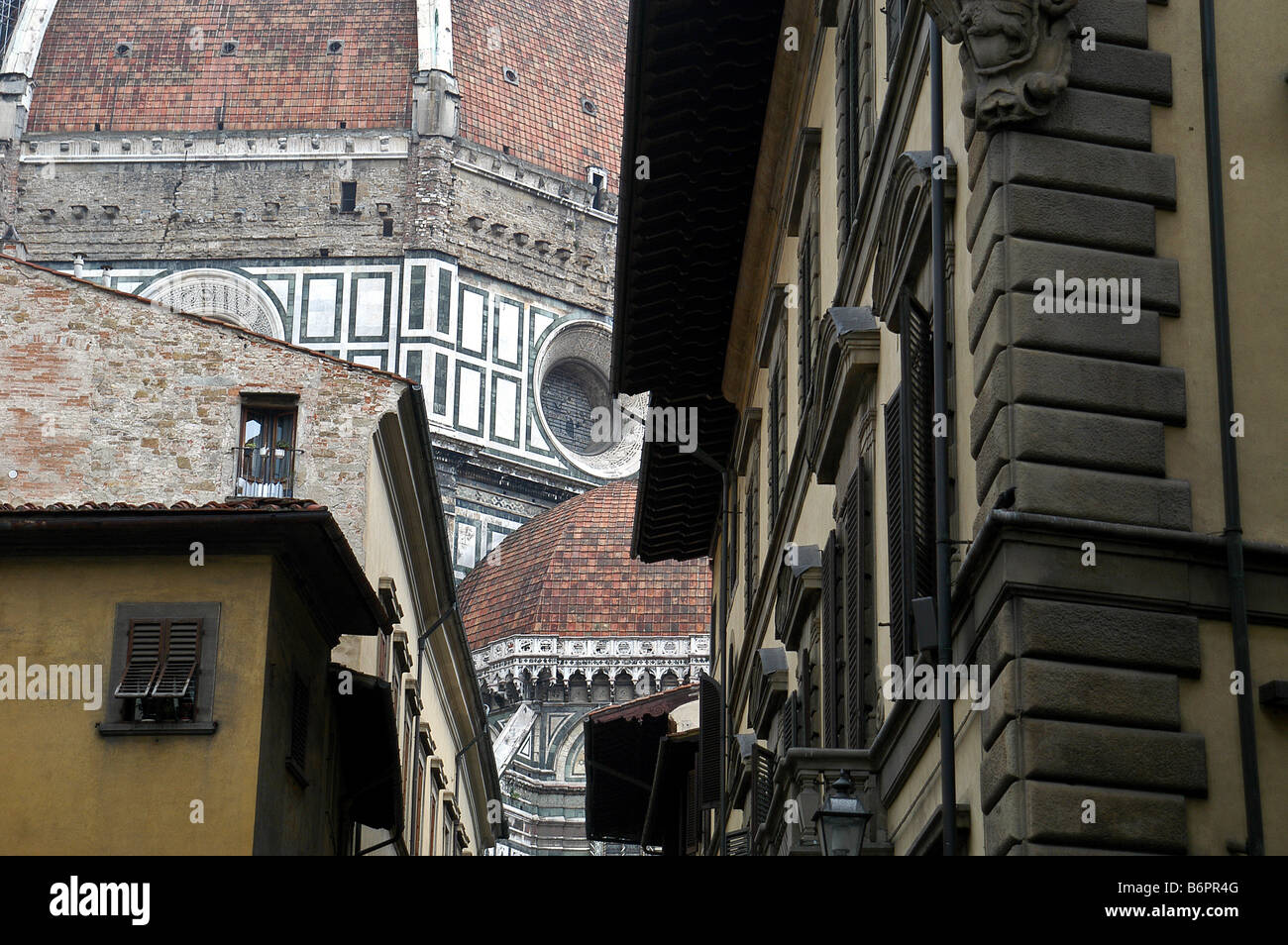 Street scene of crowded buildings in Florence Italy with the Duomo in ...
