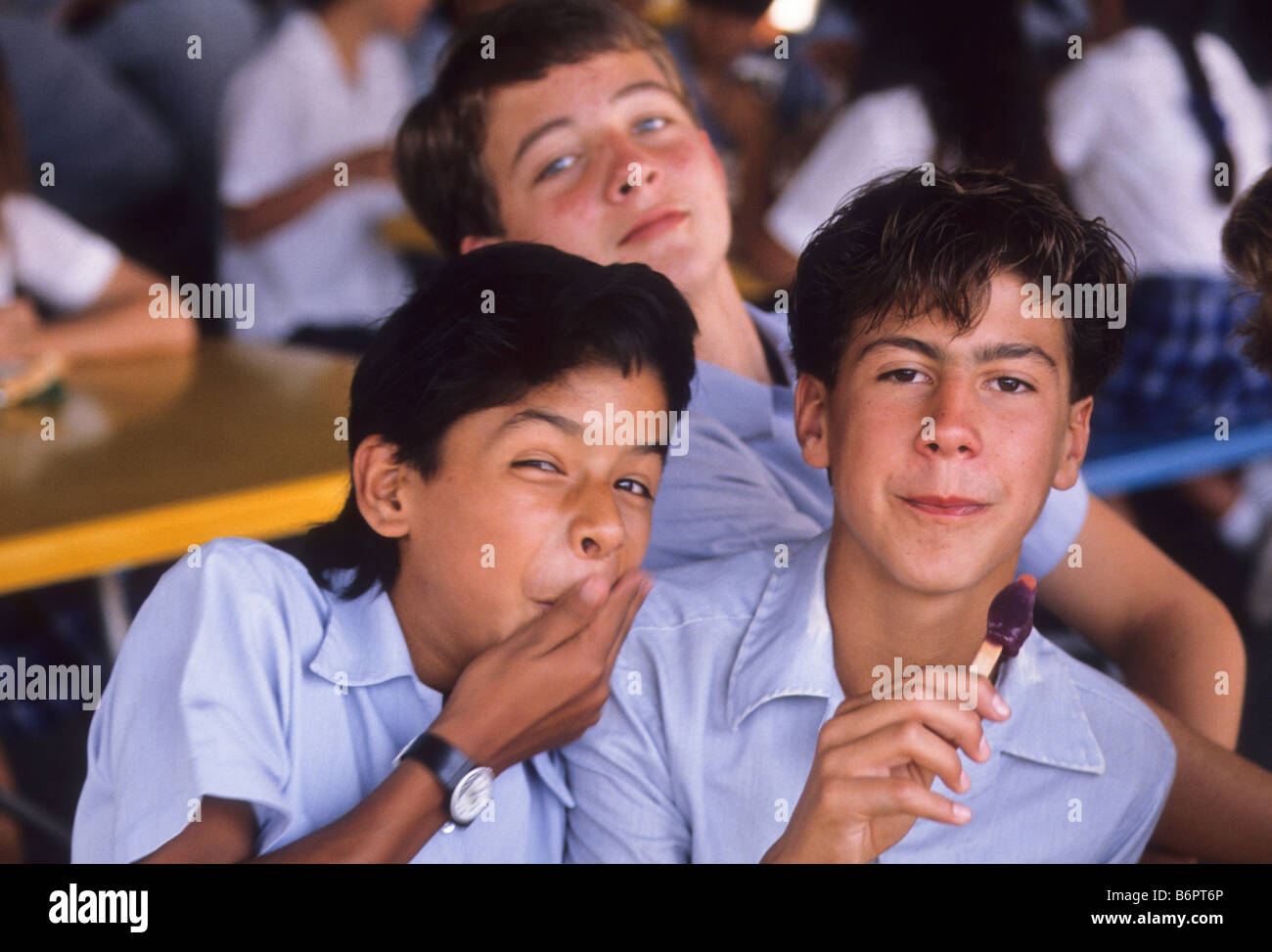Group of boys eat lunch during break at school Stock Photo - Alamy
