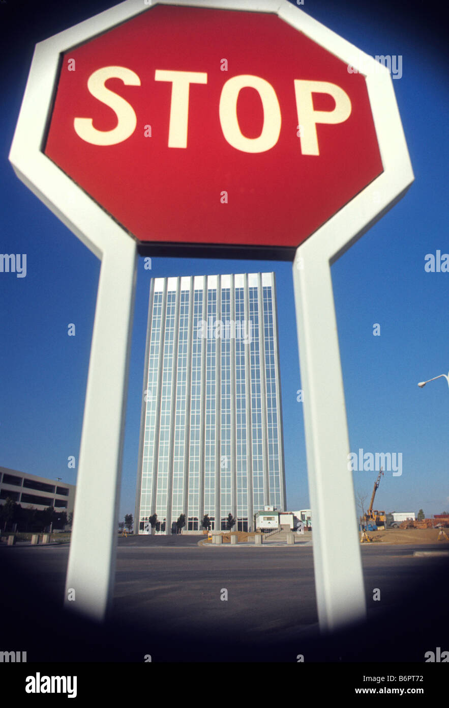 Legs of stop sign frame modern tall building as it nears finish of ...