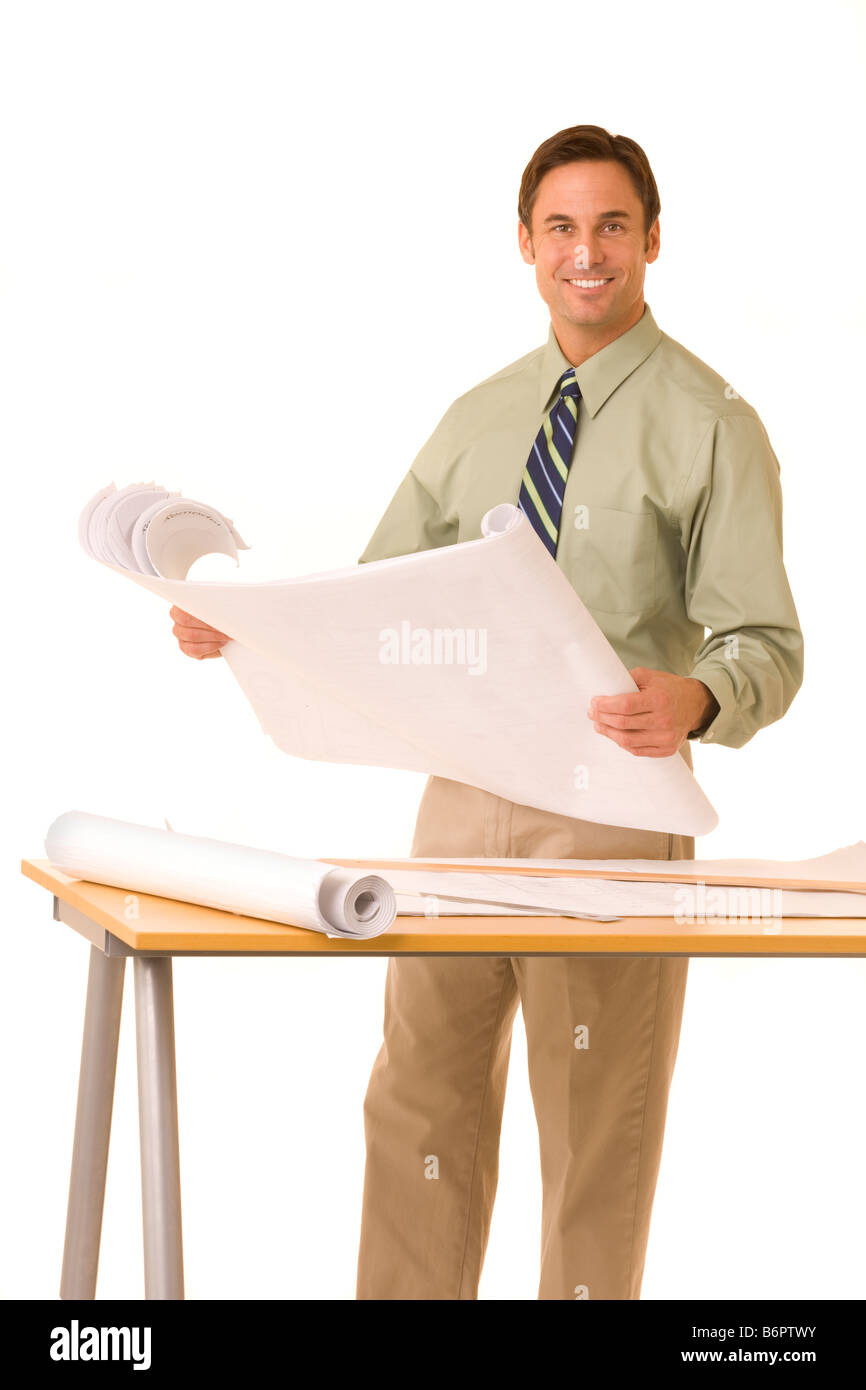 Arcitect standing at drafting table holding blueprints Stock Photo - Alamy