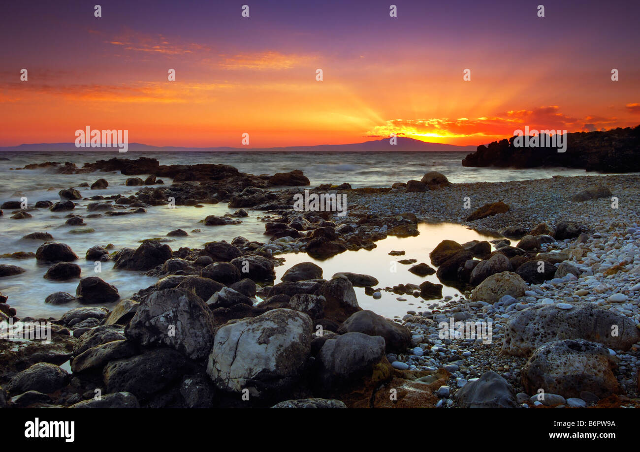 Glorious sunset over rocky sea Stock Photo - Alamy