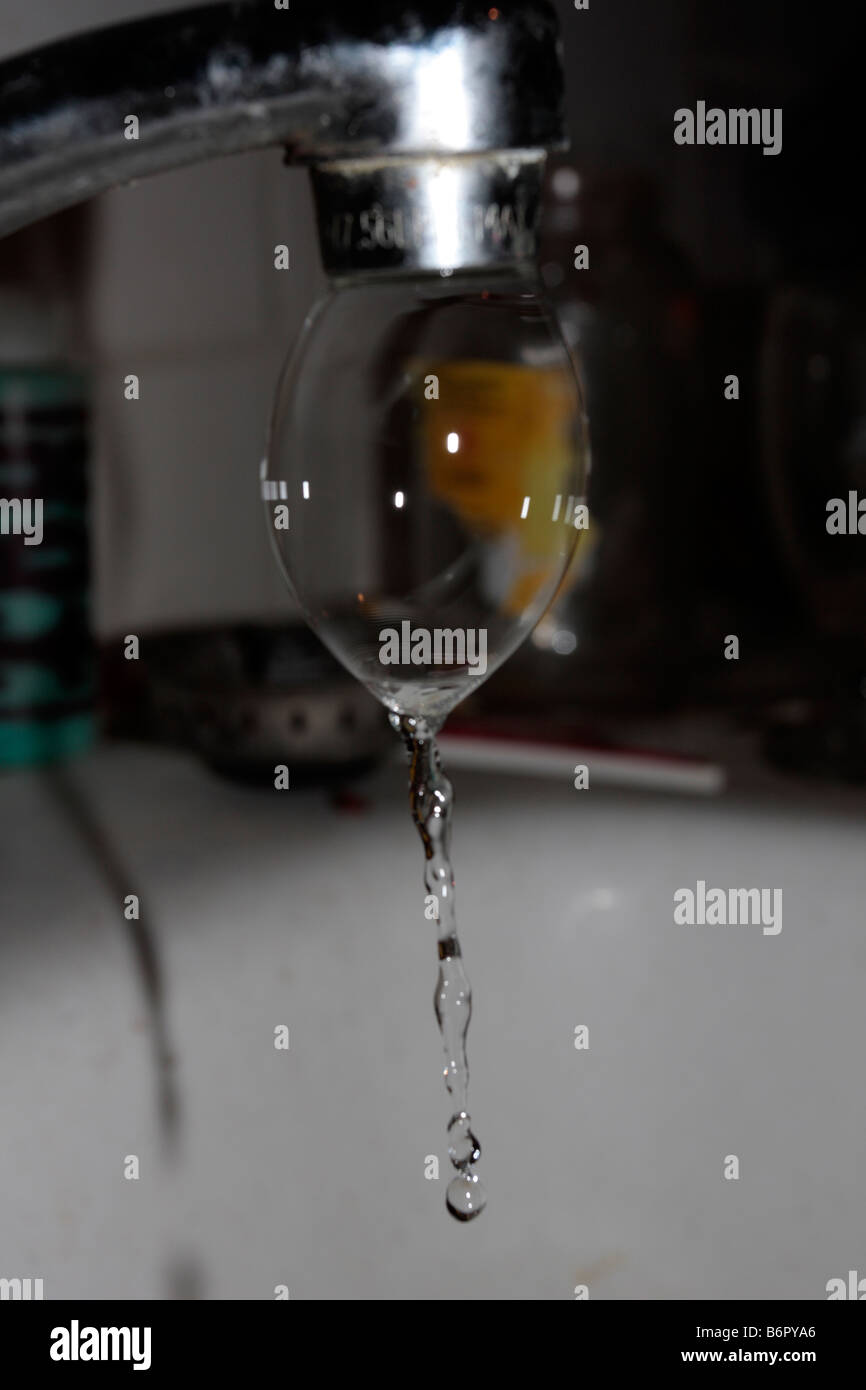 Air bubble formed on spout of water tap Stock Photo - Alamy