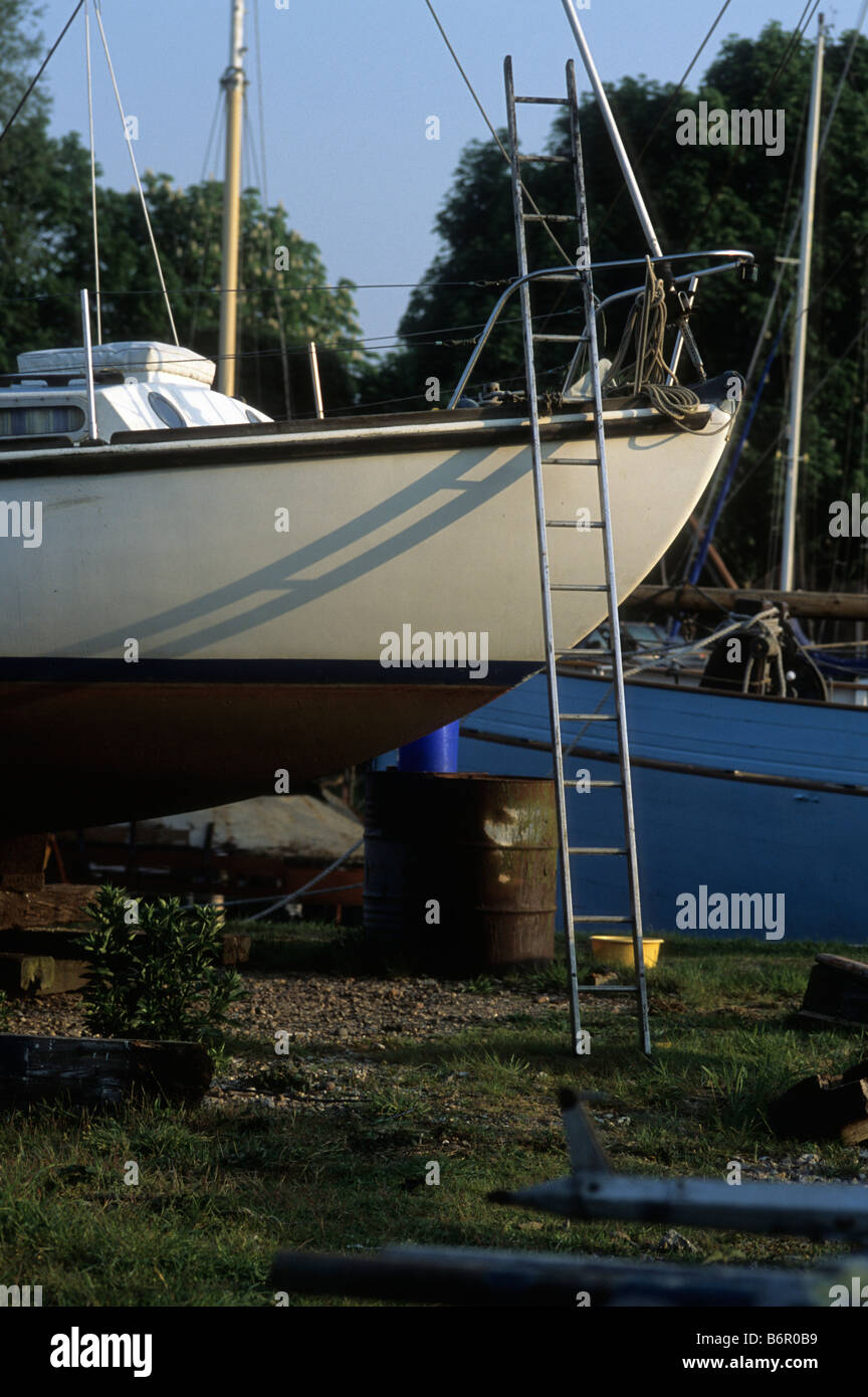 Ladder against hull of boat in boatyard Stock Photo - Alamy