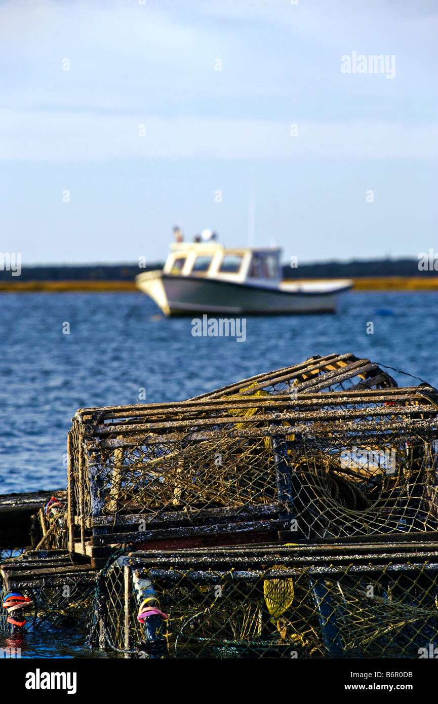 Wooden lobster traps and boat in Nauset Harbor Orleans Cape Cod MA USA ...