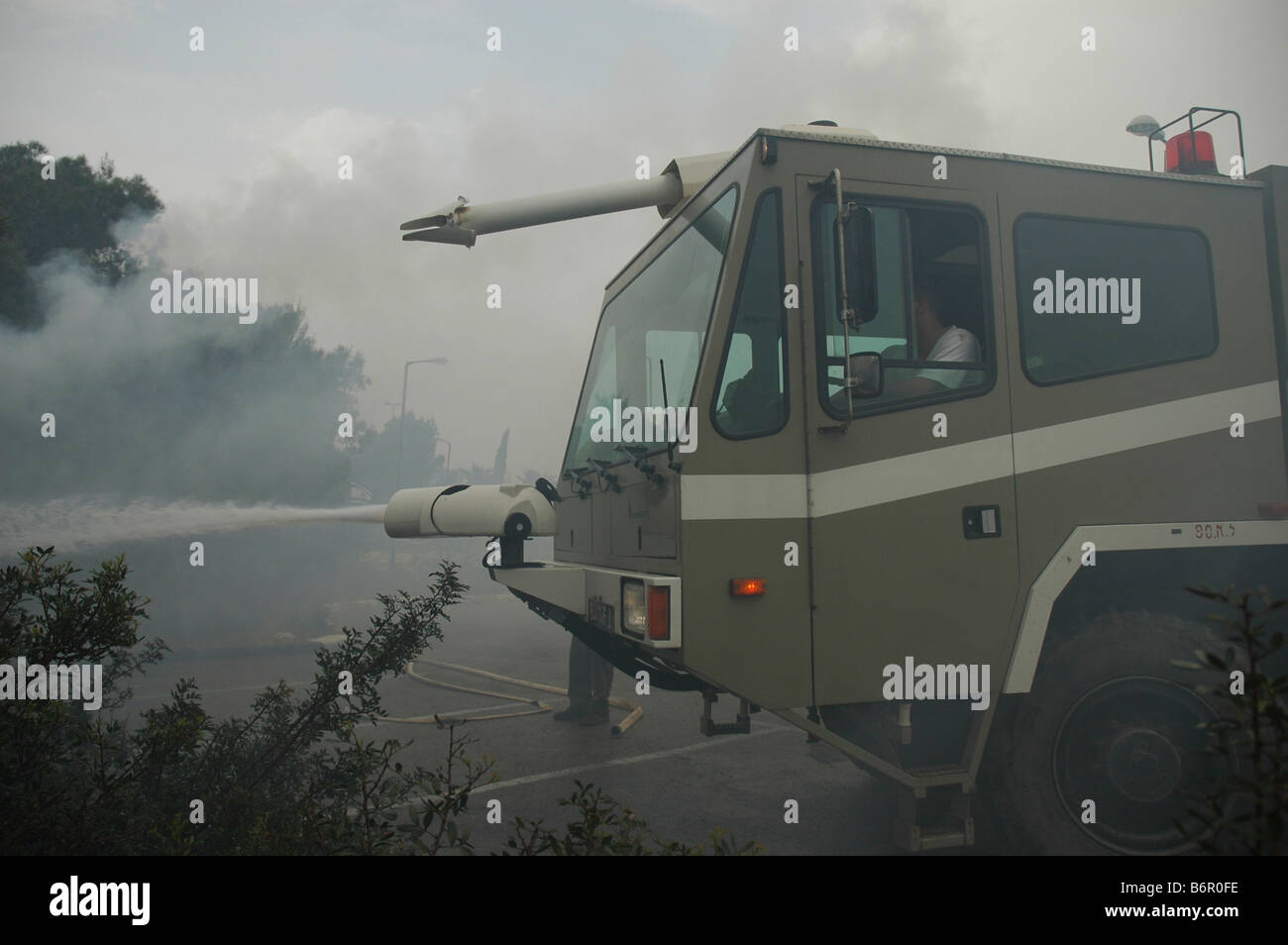 Israel Haifa Carmel Mountain Forest A fire engine cannon spraying water ...
