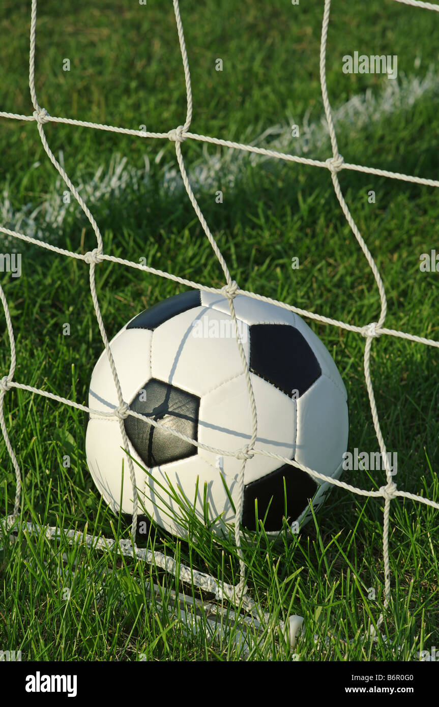Soccer ball in the goal net Stock Photo - Alamy