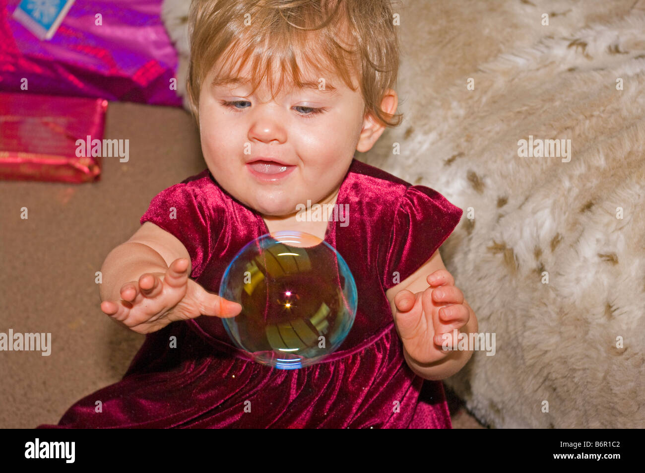 Baby Girl child Playing With Soap Bubbles at Christmas Stock Photo - Alamy