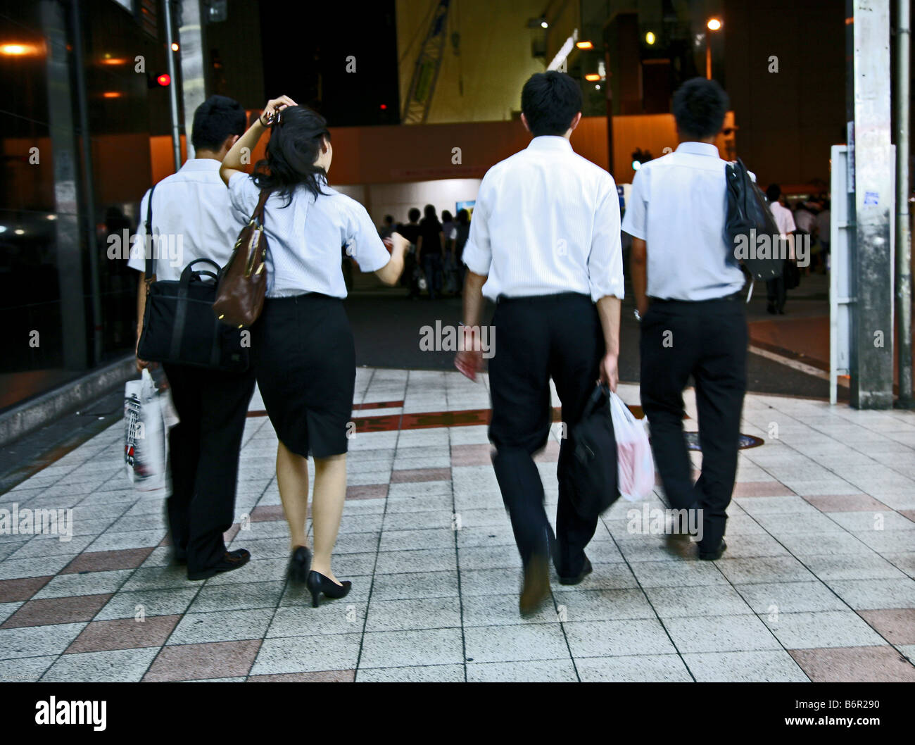 Japanese office workers walking on the street after work Stock Photo ...