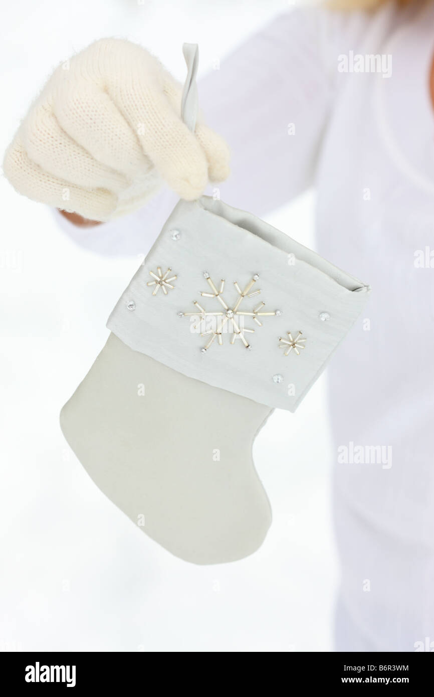 Hands with winter gloves holding Christmas Stocking Stock Photo - Alamy