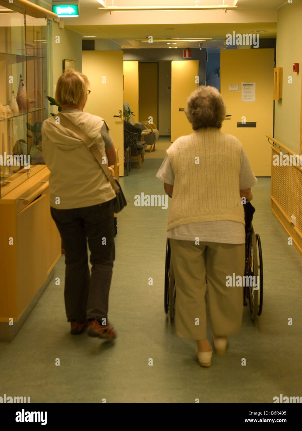 middleaged woman visiting her mother in home for old people going for a ...