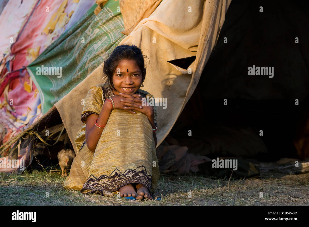 Poor nomadic indian girl sitting inside her tent home in the rural ...