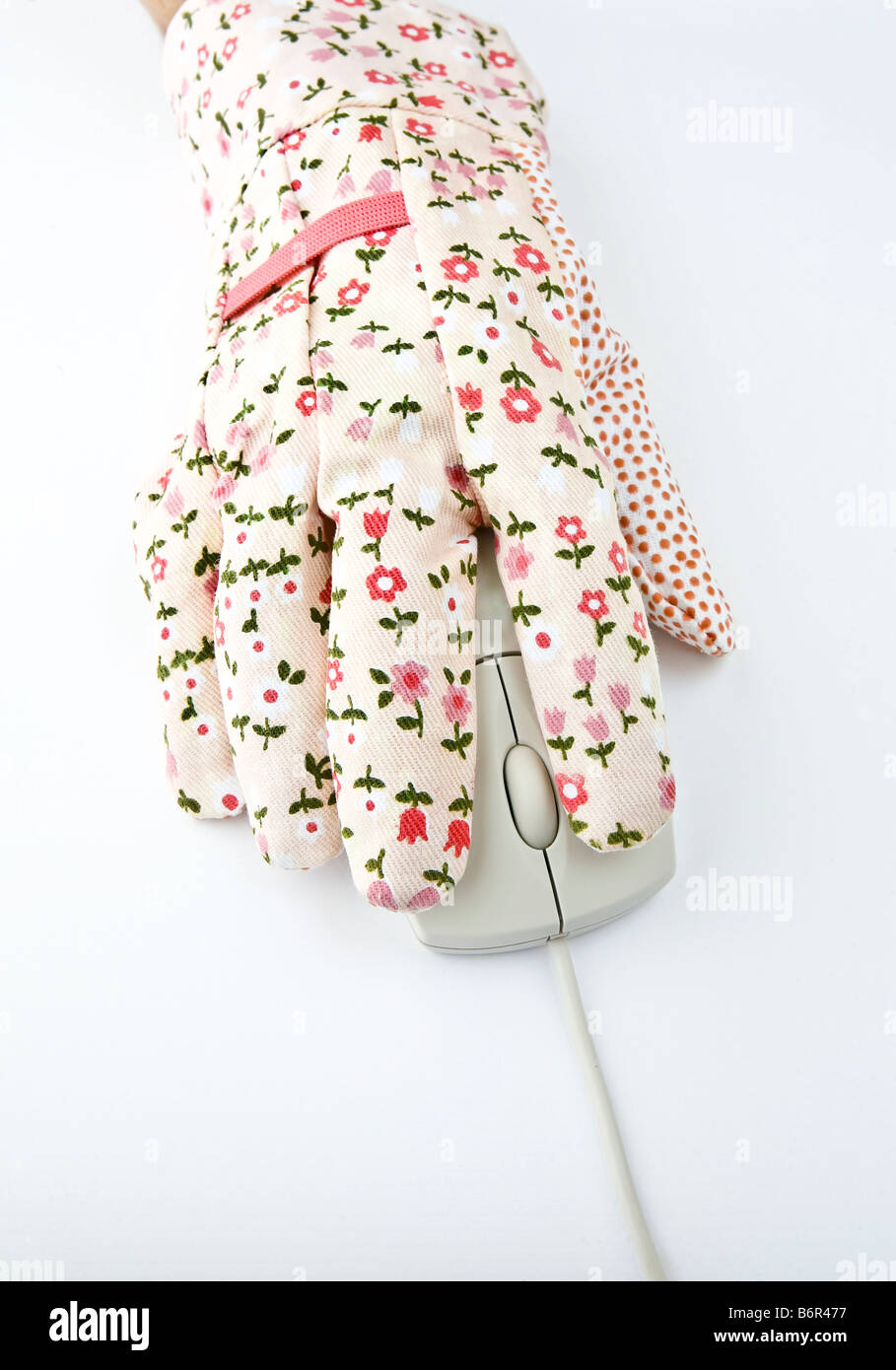 Older woman's hand in glove using computer mouse pointing device Stock ...