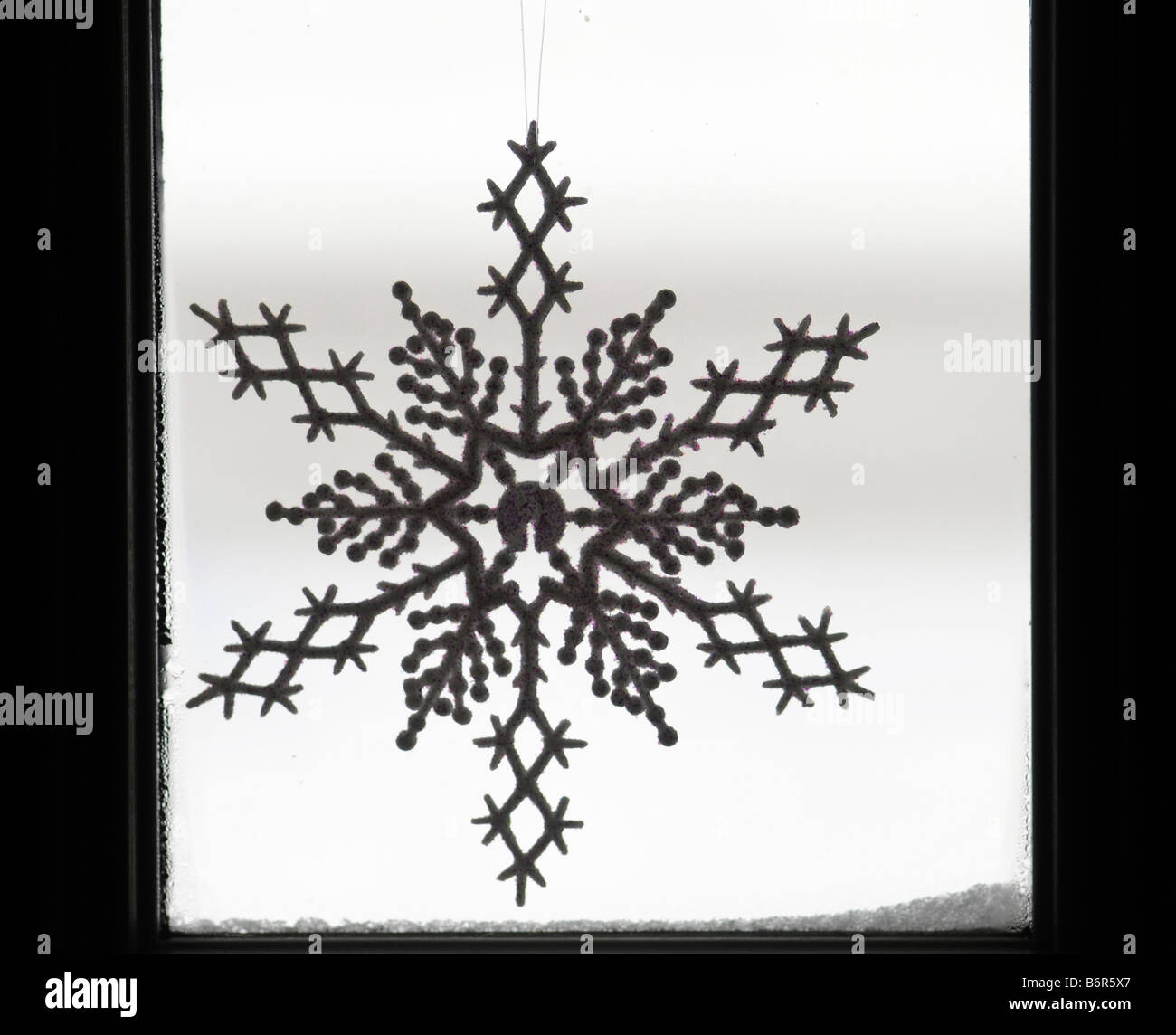 A snowflake window decoration Stock Photo - Alamy