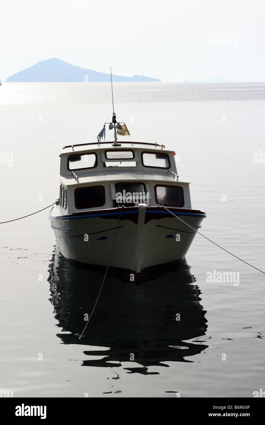 small wooden fishing boat anchored sunset Stock Photo - Alamy