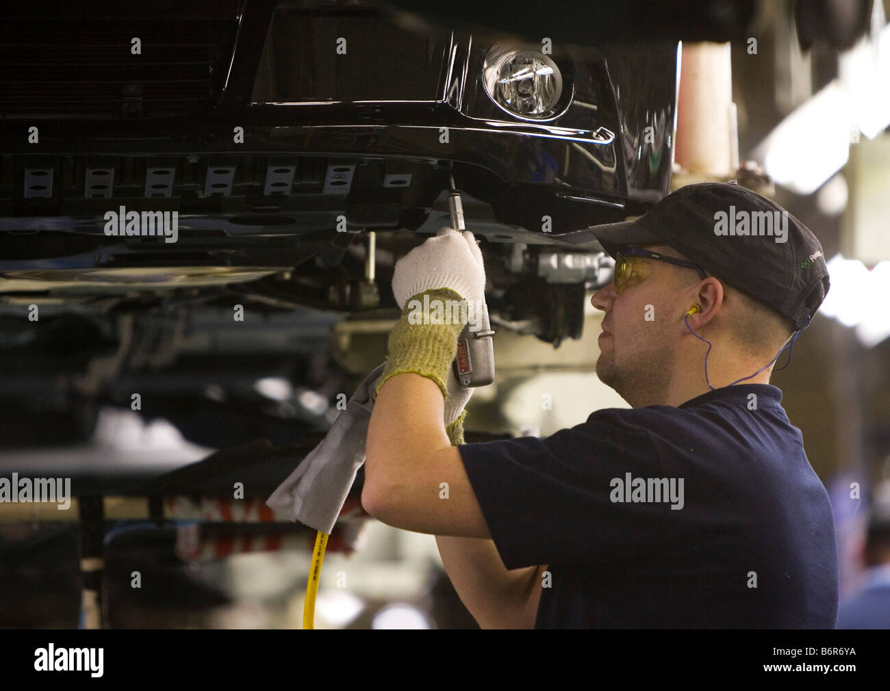 Workers at Toyota Final Assembly production line fit parts to the ...