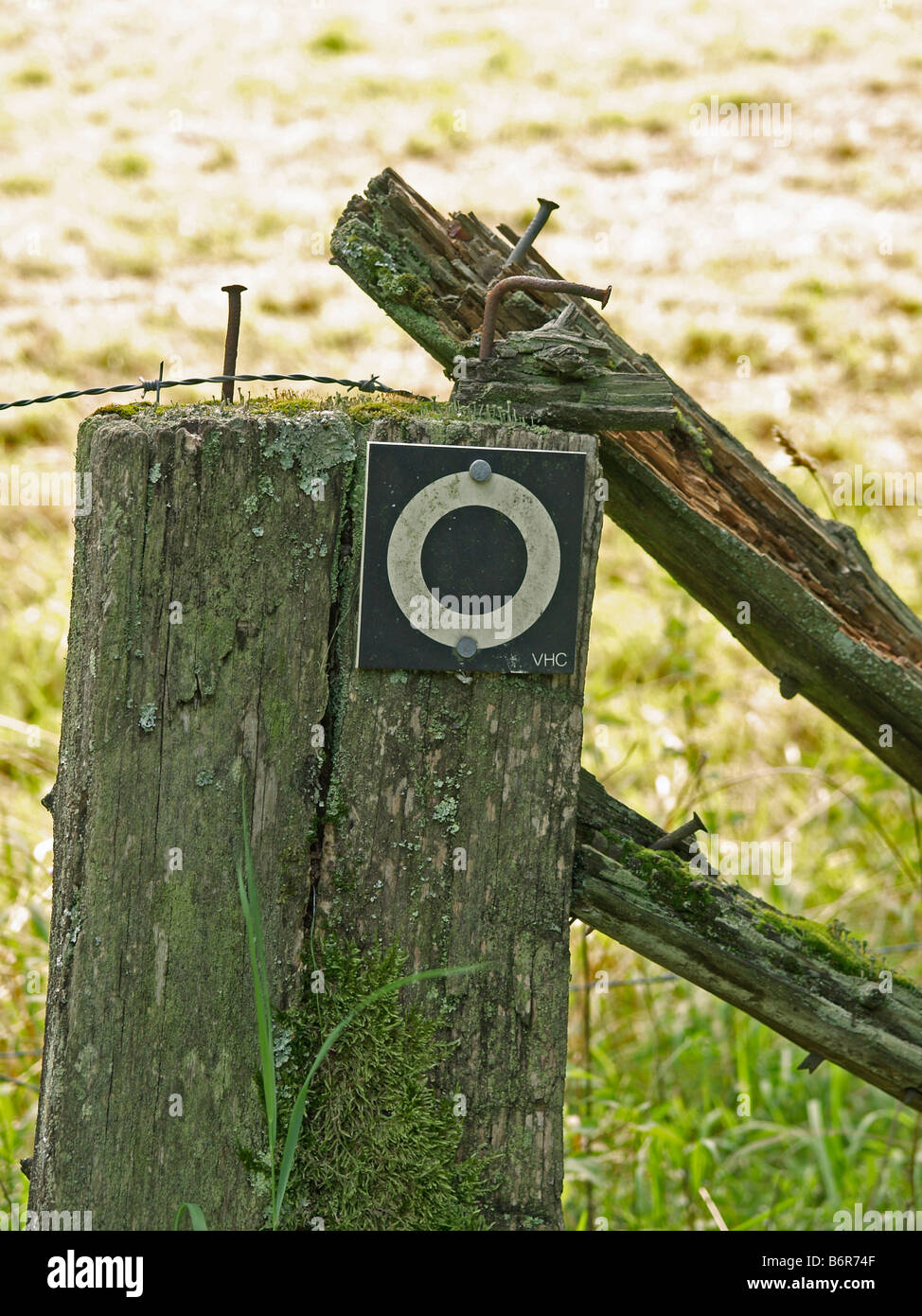 sign for hiking route with a symbol on fence post in Vogelsberg in ...