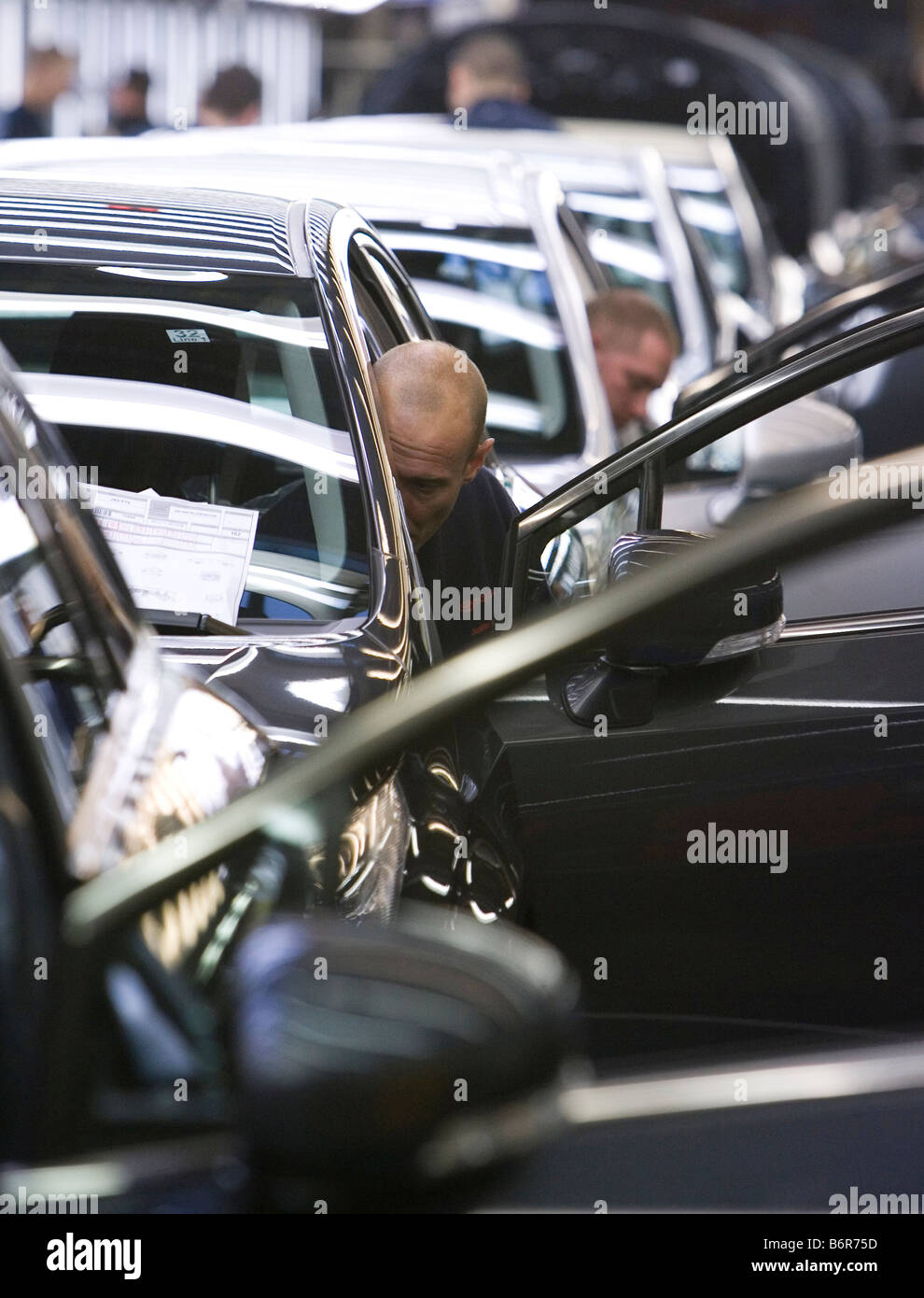 Workers at Toyota Final Assembly production line do a final quality ...