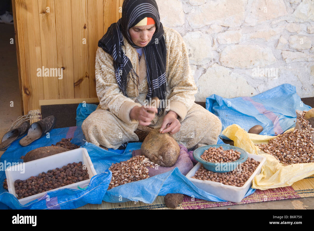 Morocco North Africa December Moroccan woman using a stone to break ...