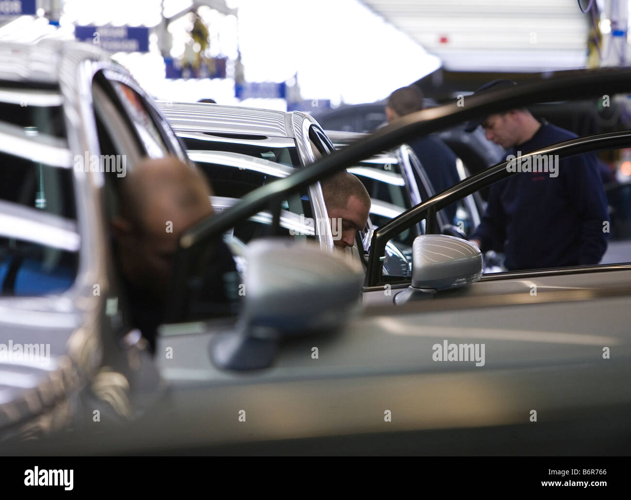 Workers at Toyota Final Assembly production line do a final quality ...
