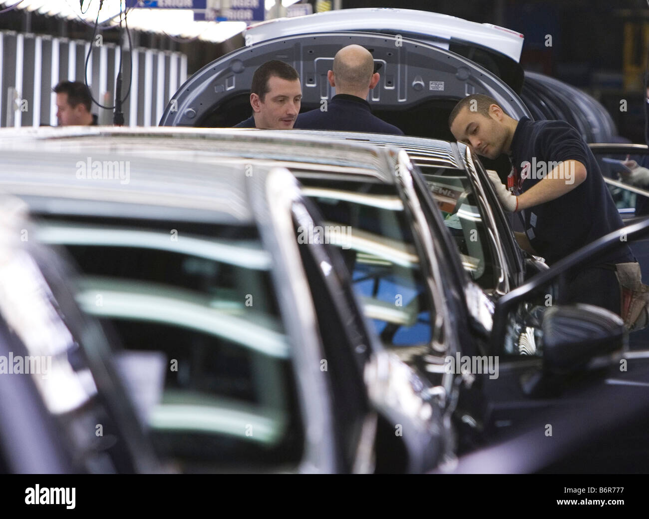 Workers at Toyota Final Assembly production line do a final quality ...