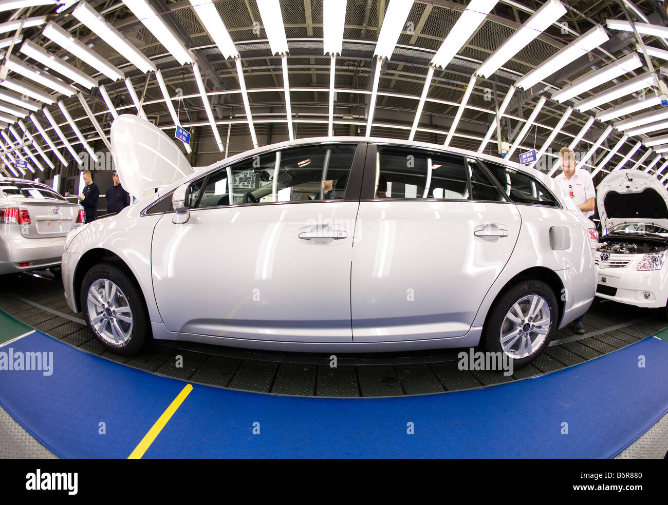 Workers at Toyota Final Assembly production line do a final quality ...