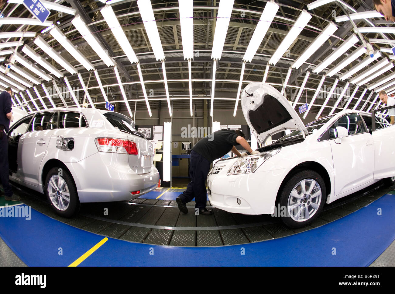 Workers at Toyota Final Assembly production line do a final quality ...