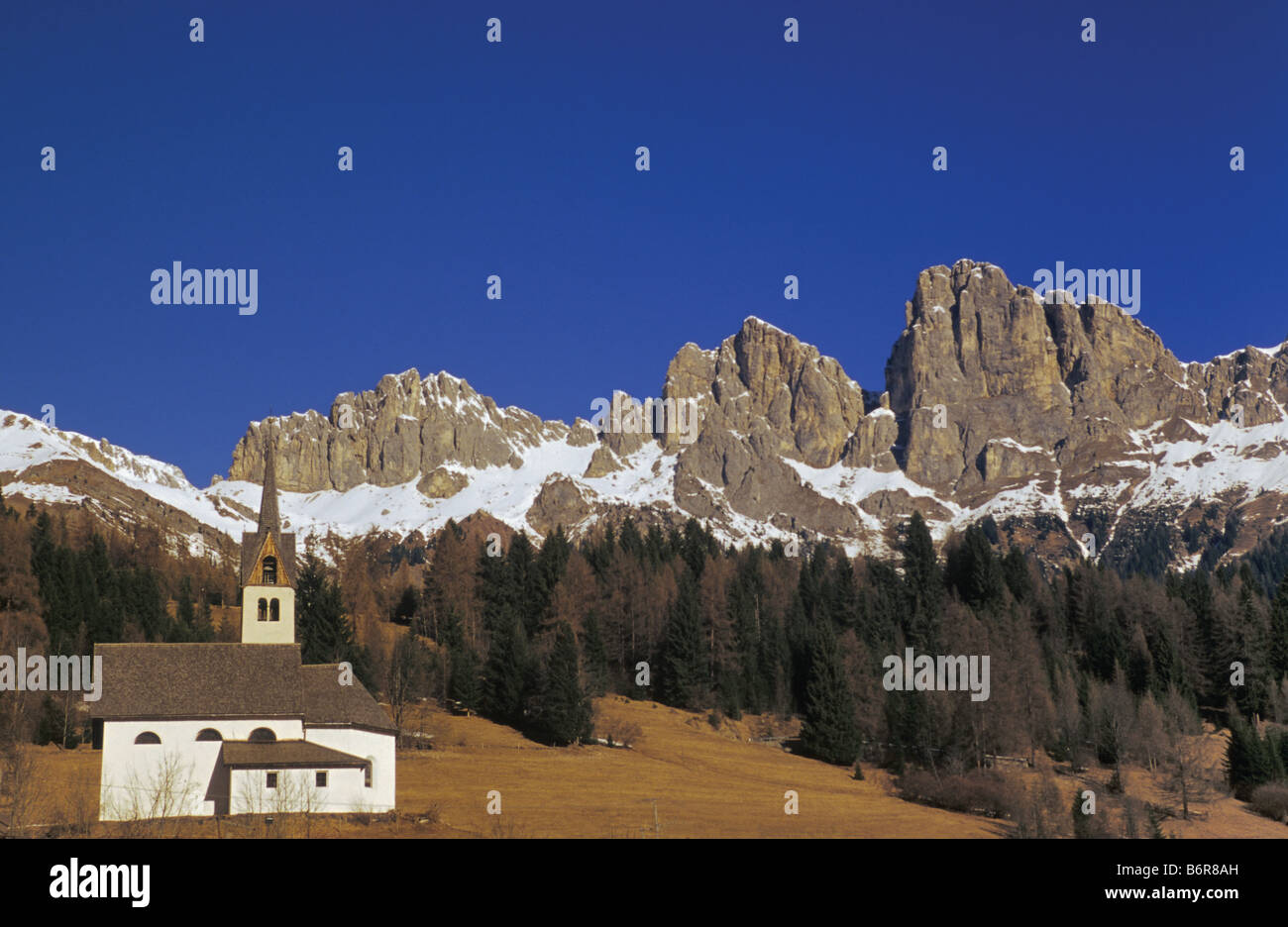 Church in village of Falcade with Marmolada mountain group in winter ...