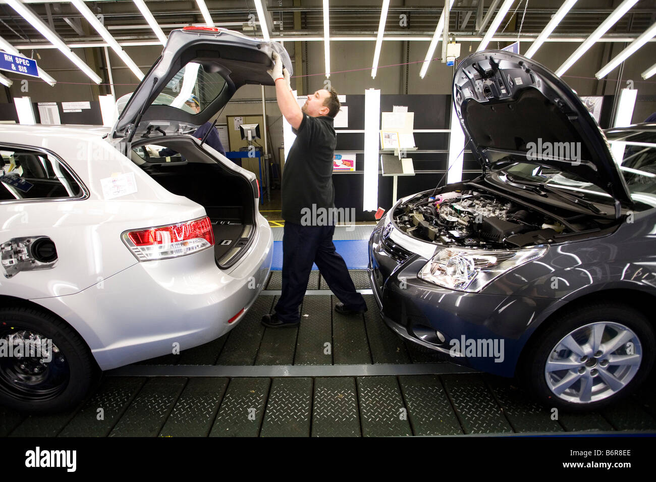 Workers at Toyota Final Assembly production line do a final quality ...