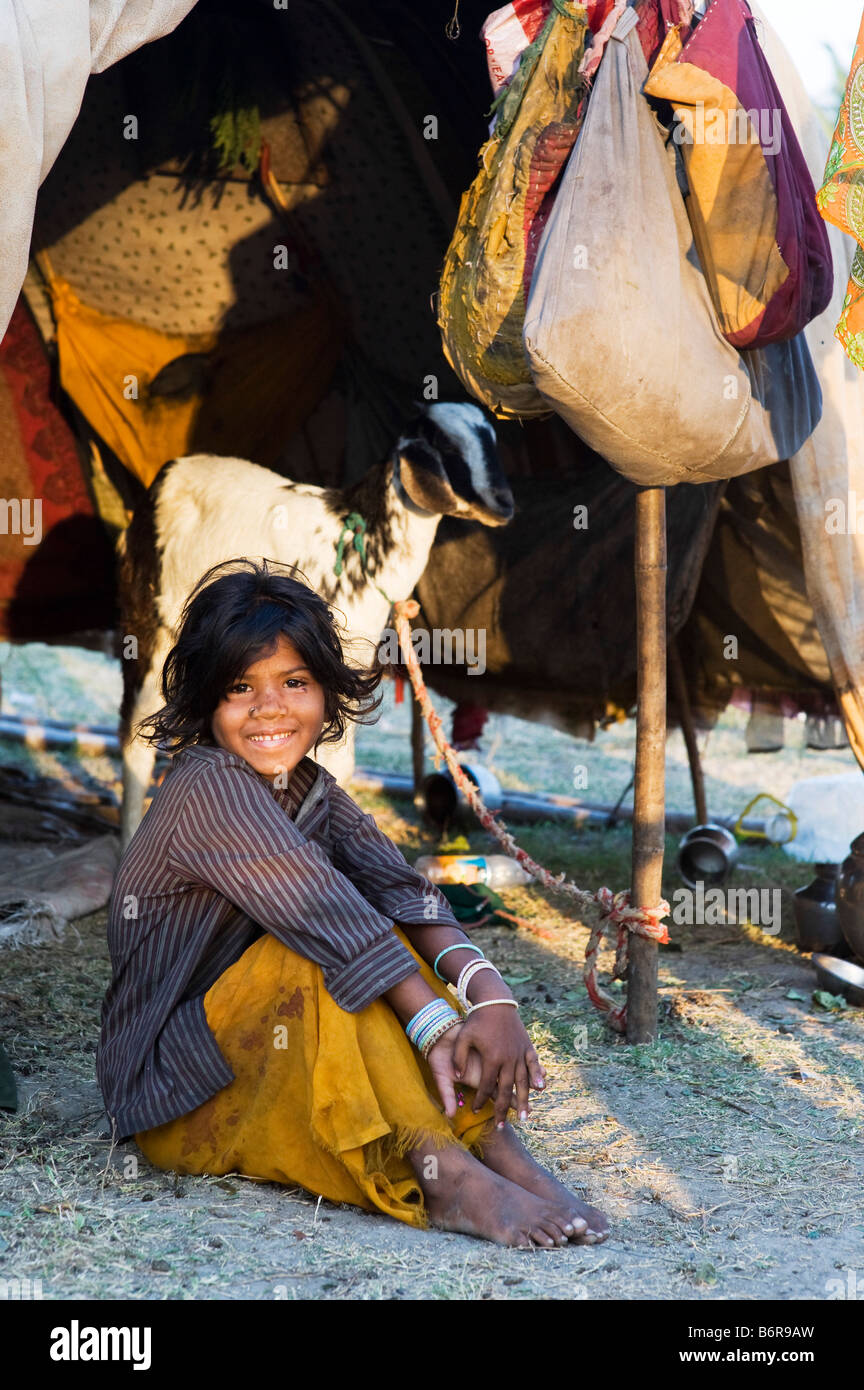 Poor nomadic young Indian girl sitting outside her tent home in the ...