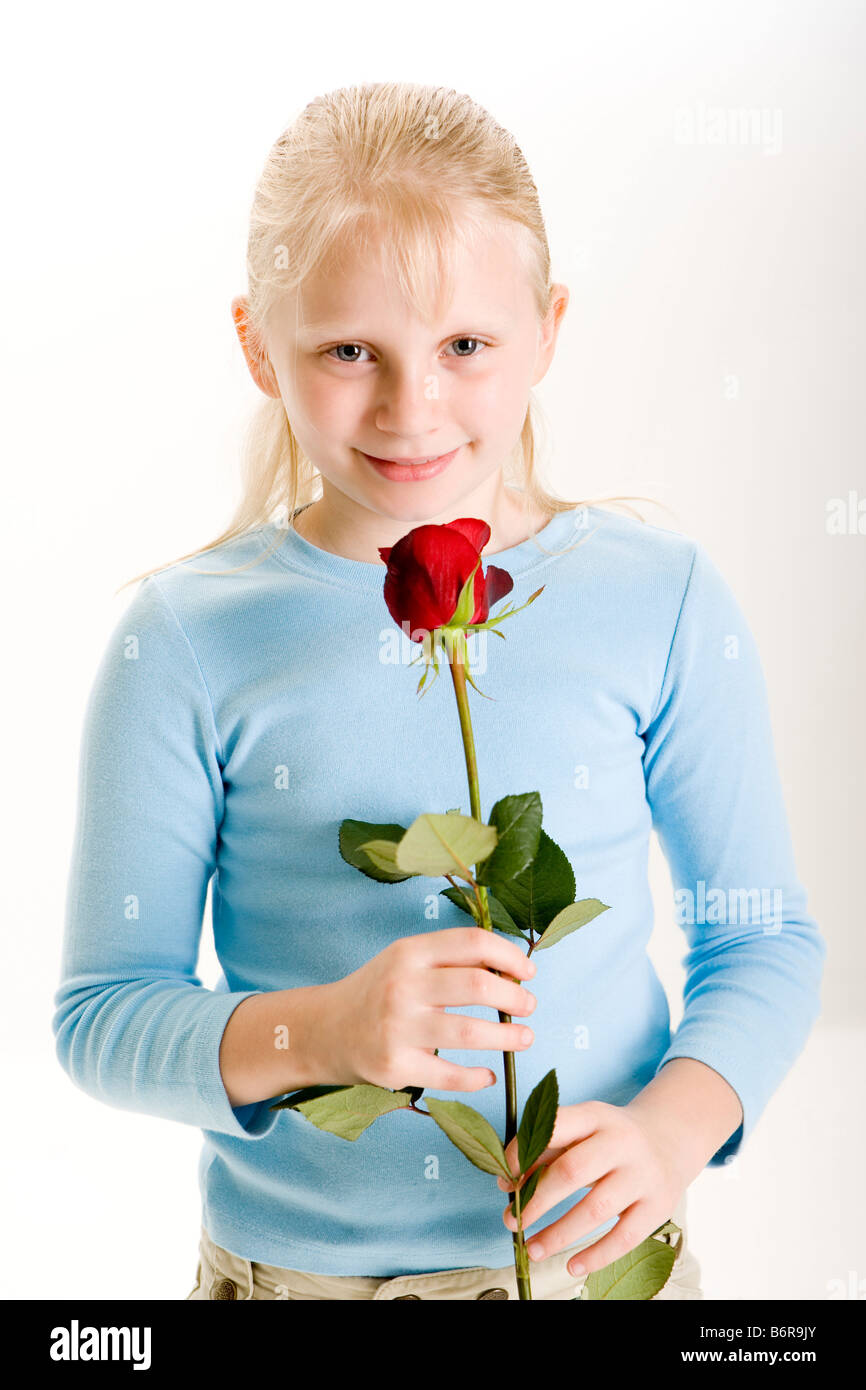 One girl holding single rose smiling close up Stock Photo - Alamy