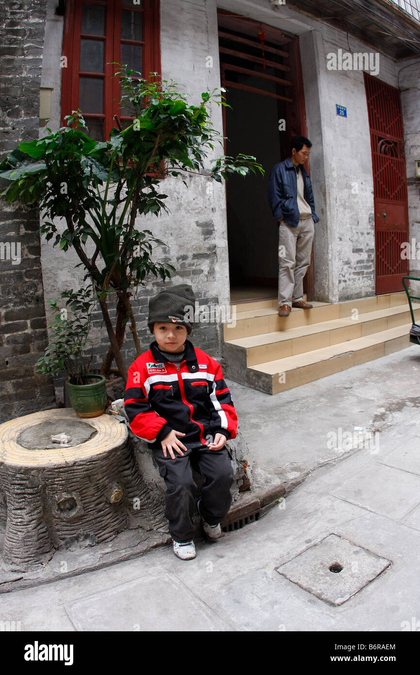 Chinese boy playing outside uncles house in Cantonese Sidetreets Canton ...