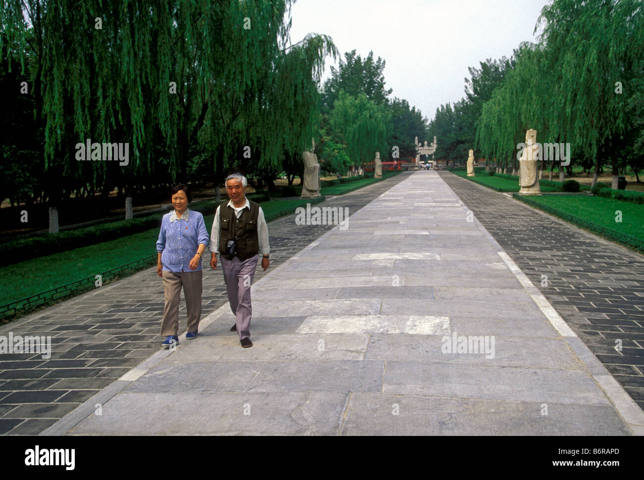 Chinese people man and woman tourists and stone statues along Spirit ...