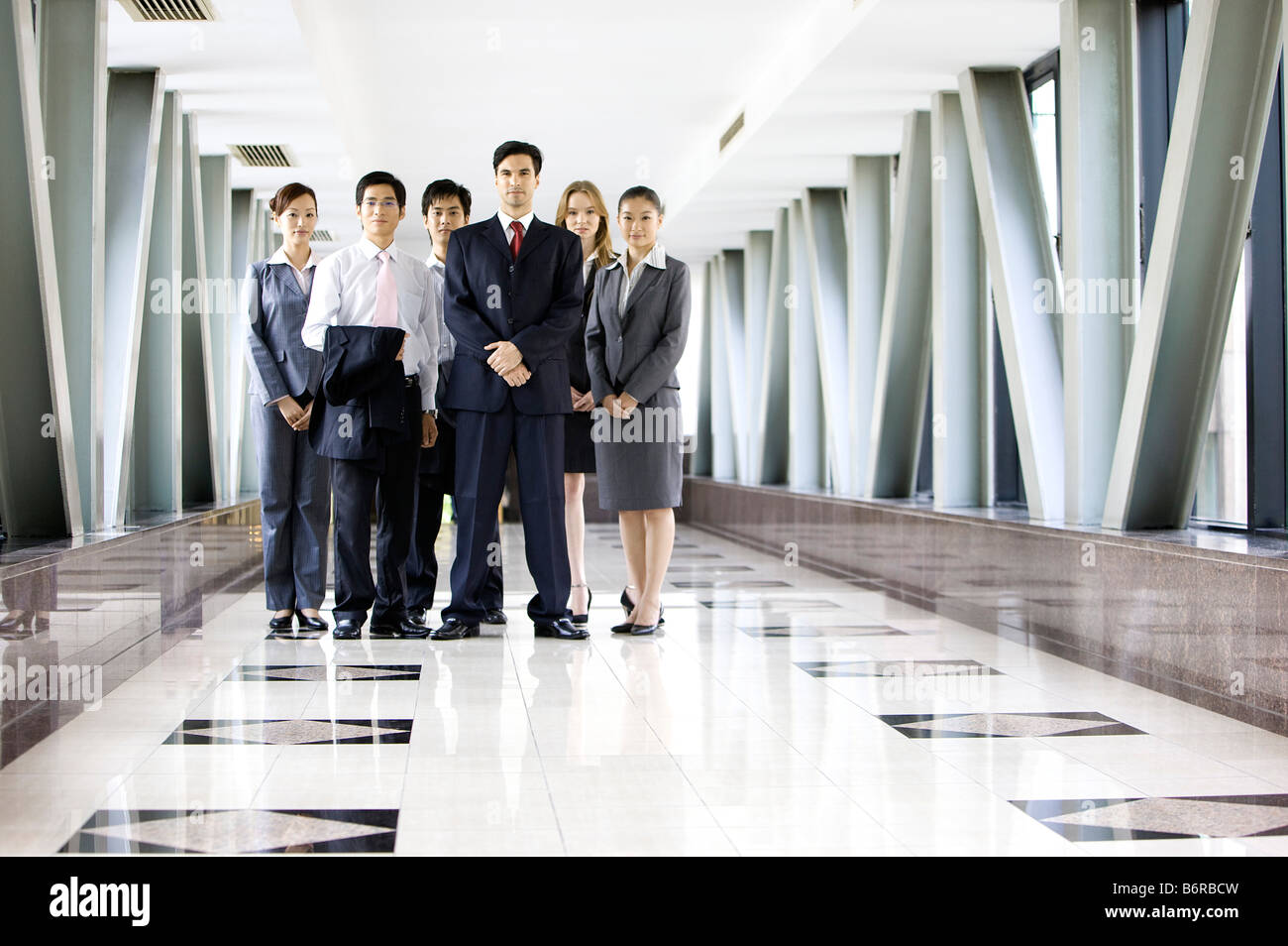 Business people standing in the office building and looking at the ...